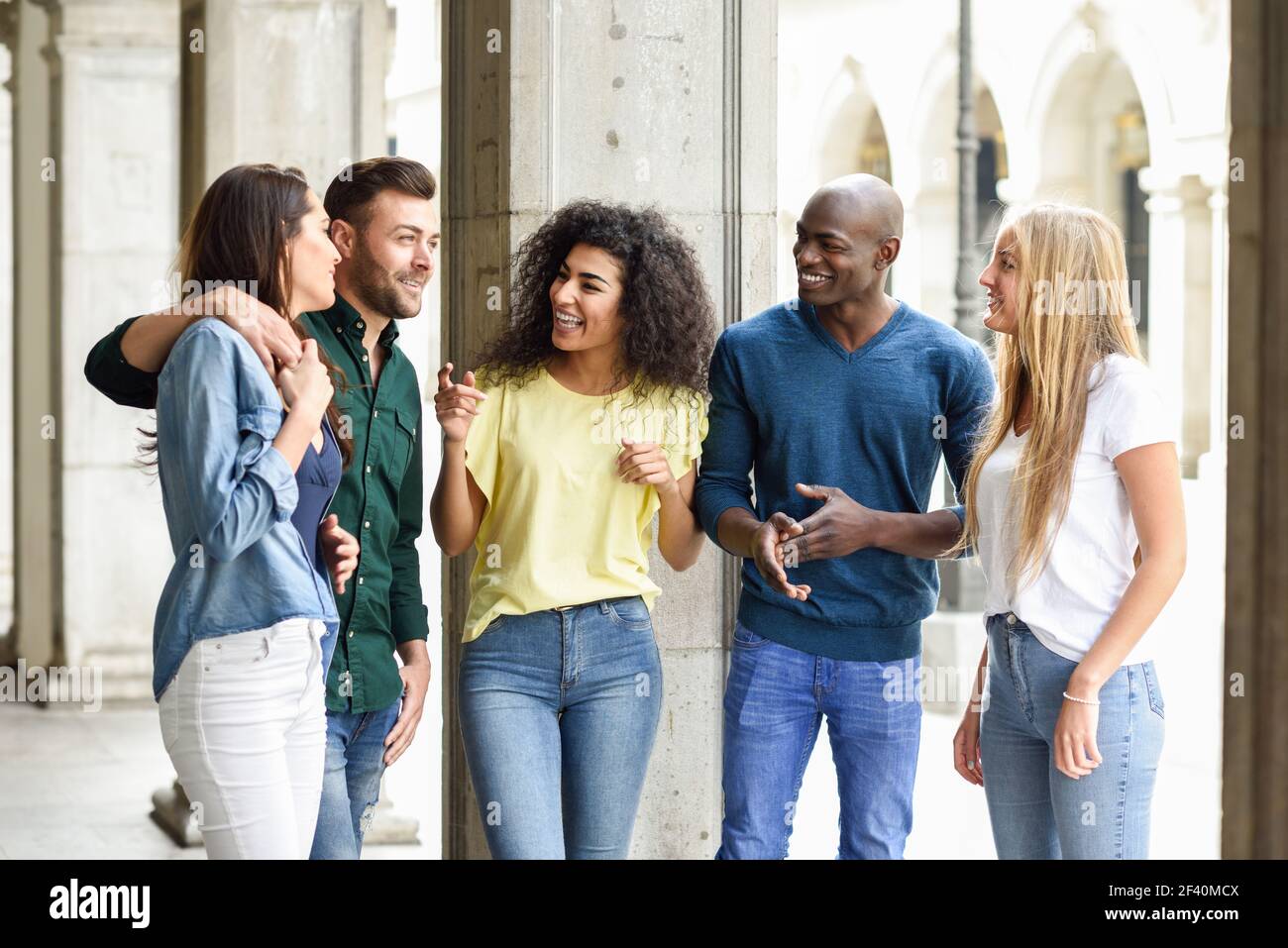 Multi-ethnic group of young people having fun together outdoors in ...