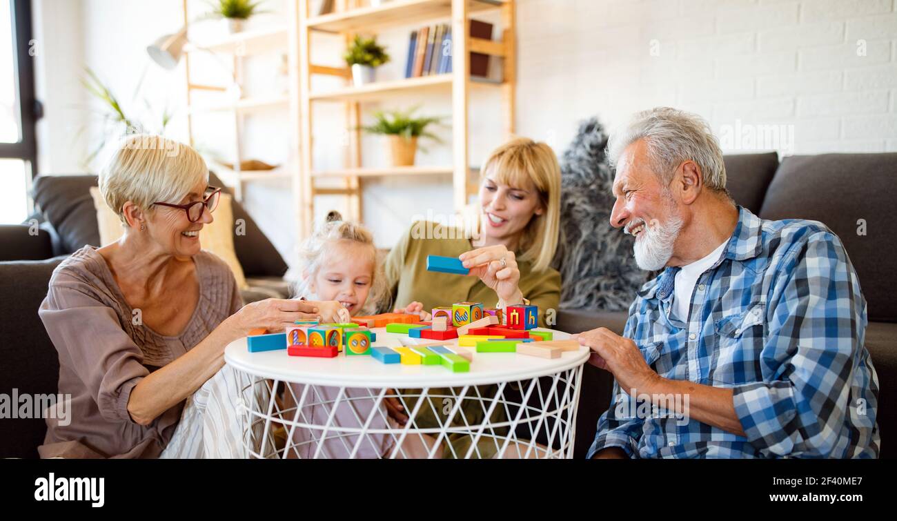 Senior grandparents playing with grandchildren and having fun with ...