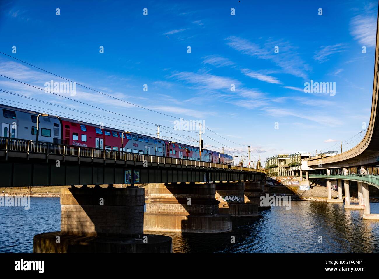 A Commuter train of the Austrian Railways crossing the Danube River in ...