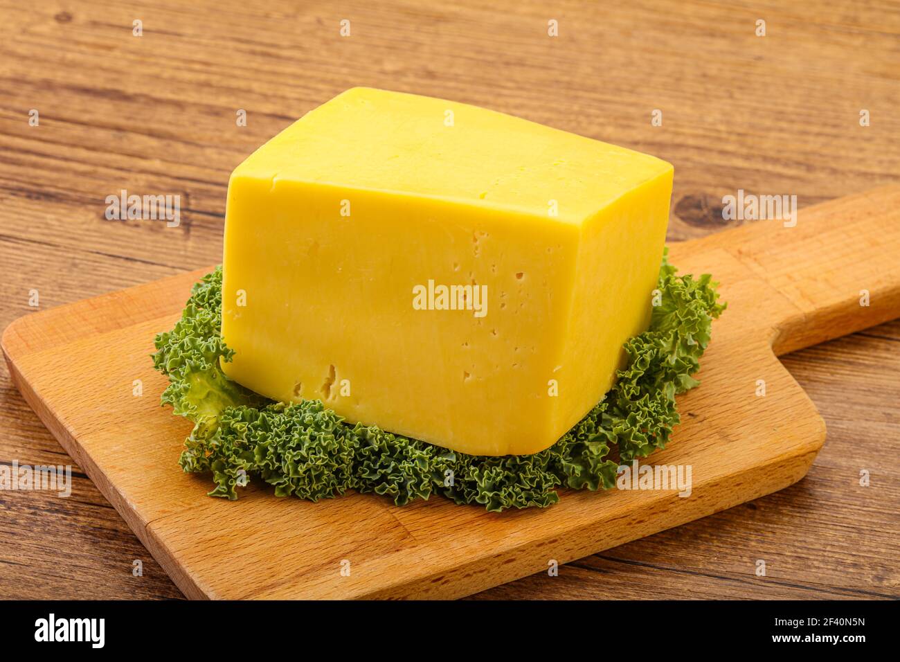 Yellow tilsiter cheese dairy product brick Stock Photo - Alamy