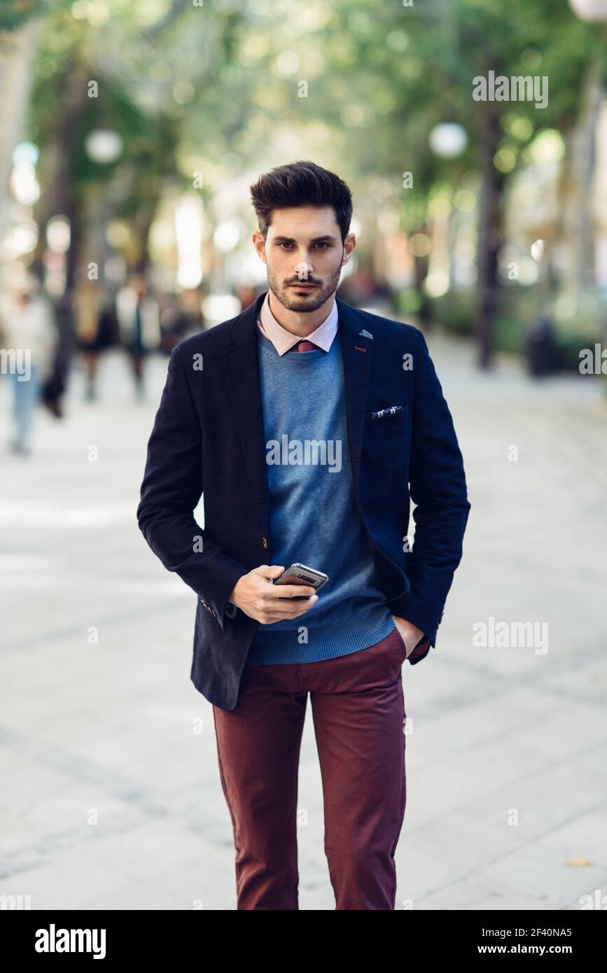 Attractive man in the street wearing british elegant suit with smart ...
