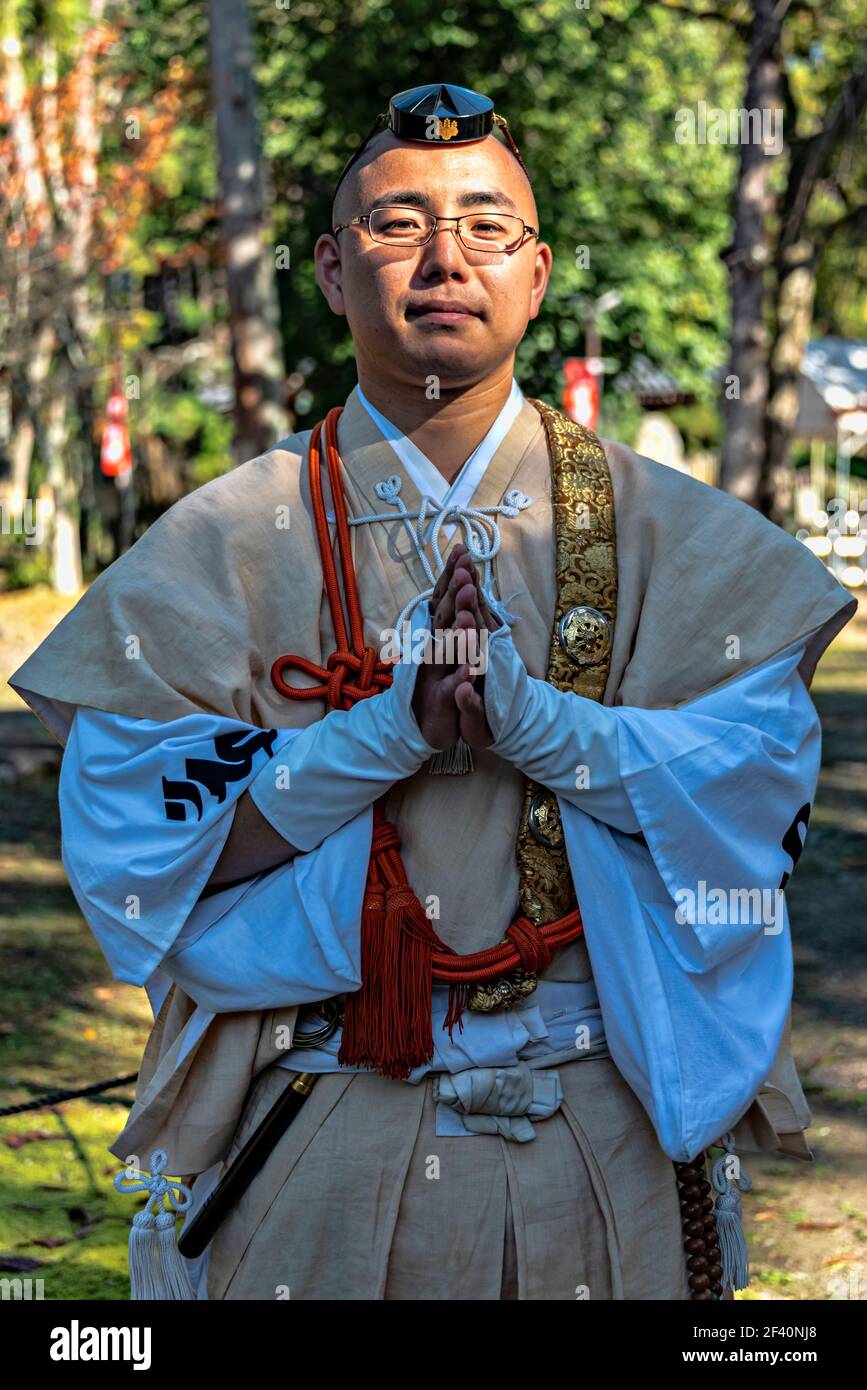 Monk saluting with a blessing posture, Daigo-ji temple grounds. One of ...