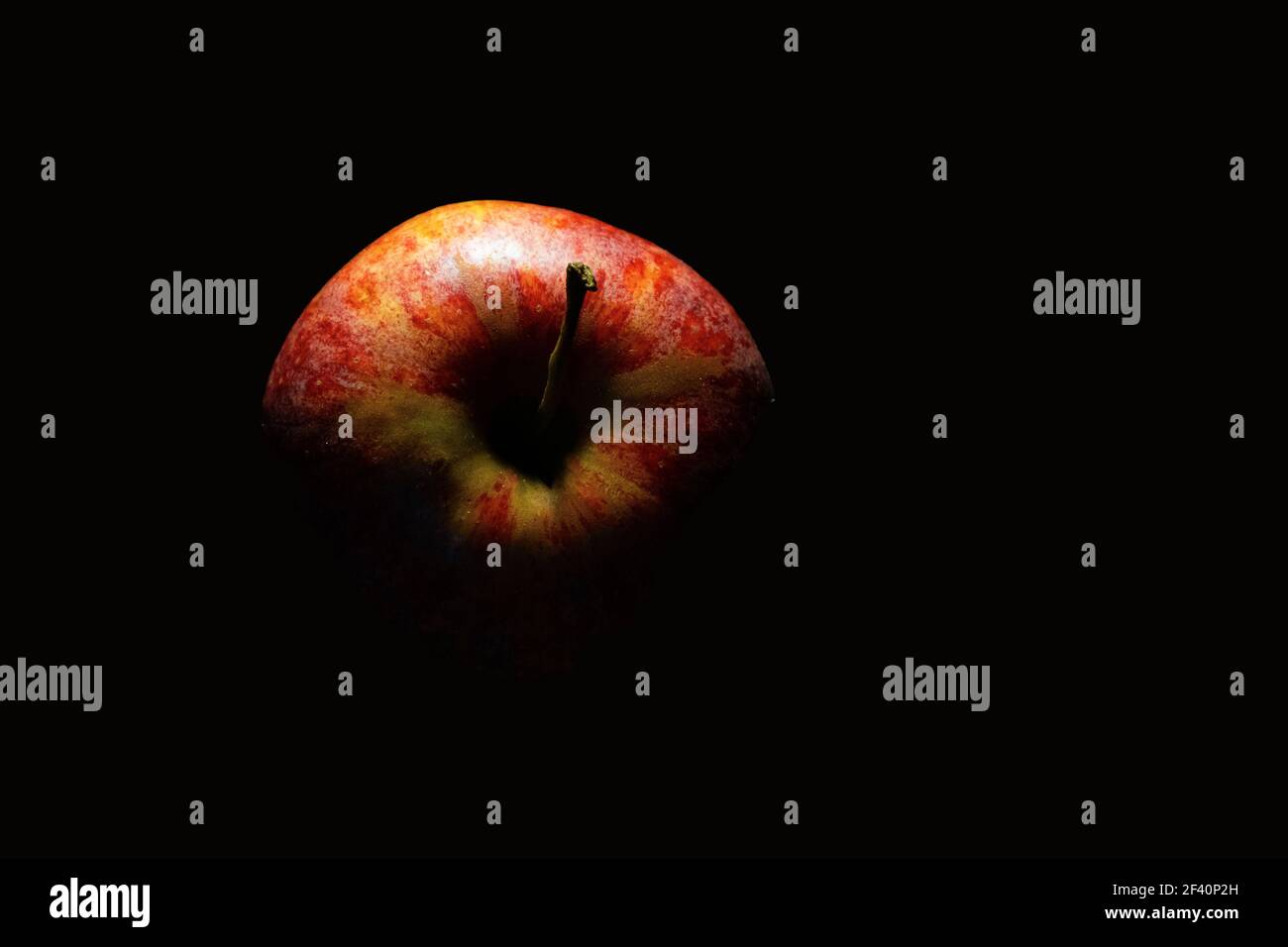 red apple in the shadow against black background Stock Photo - Alamy