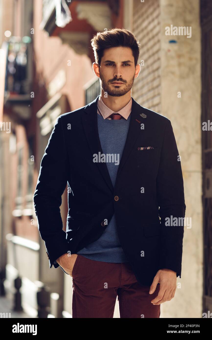 Attractive man in the street wearing british elegant suit. Young ...