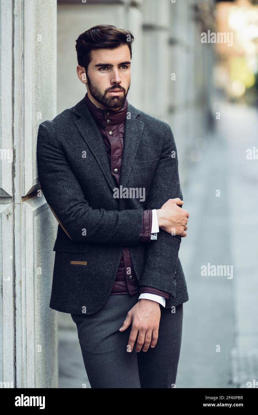 Young bearded man, model of fashion, in urban background wearing ...