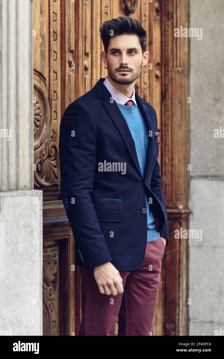 Attractive man in the street wearing british elegant suit. Young ...
