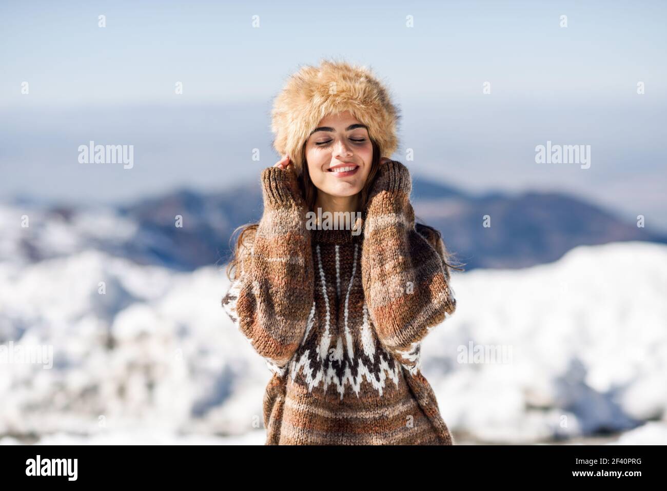 Beautiful woman enjoying the snowy mountains in winter, in Sierra ...