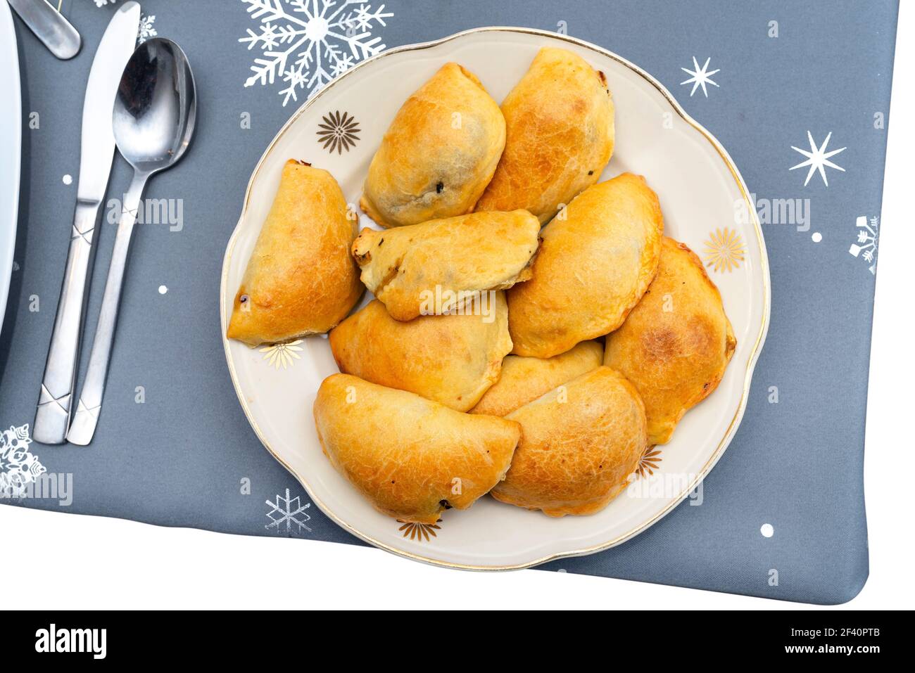 Baked golden dumplings in a pie lying on a holiday table on a plate ...