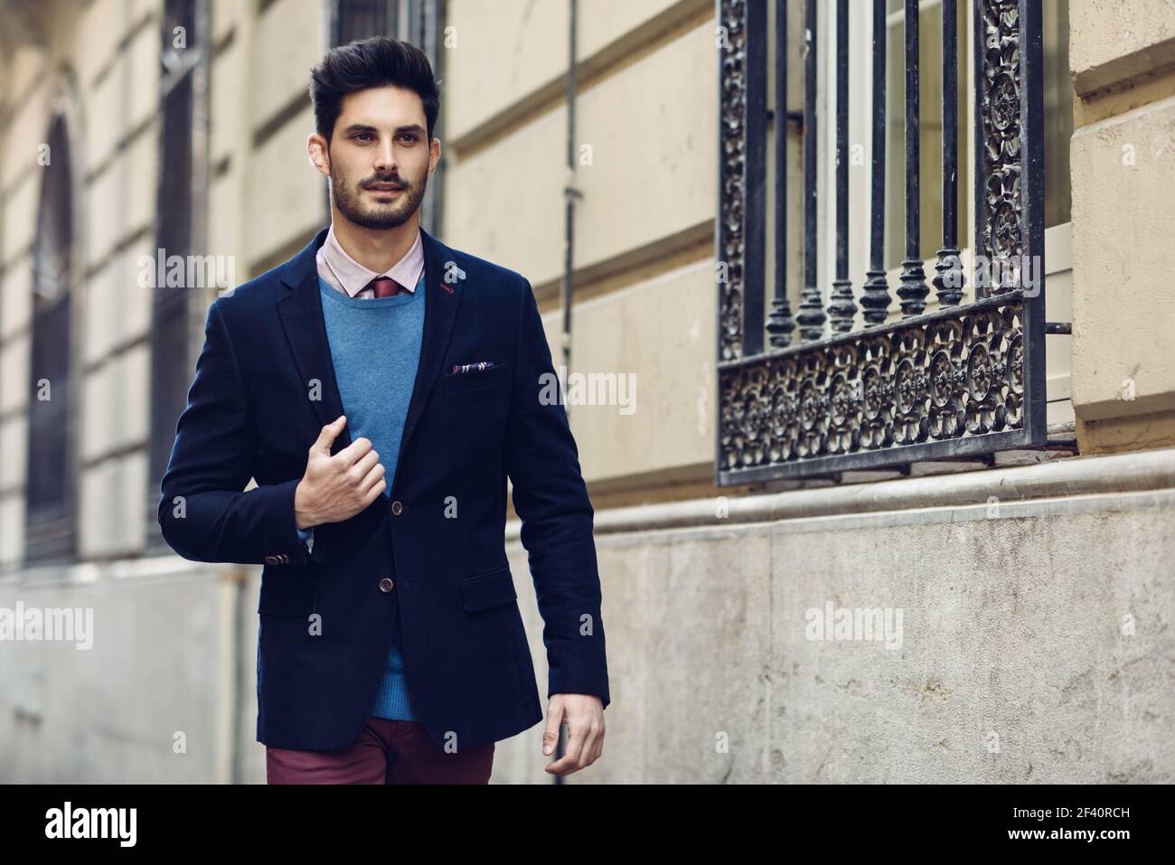 Attractive man in the street wearing british elegant suit. Young ...