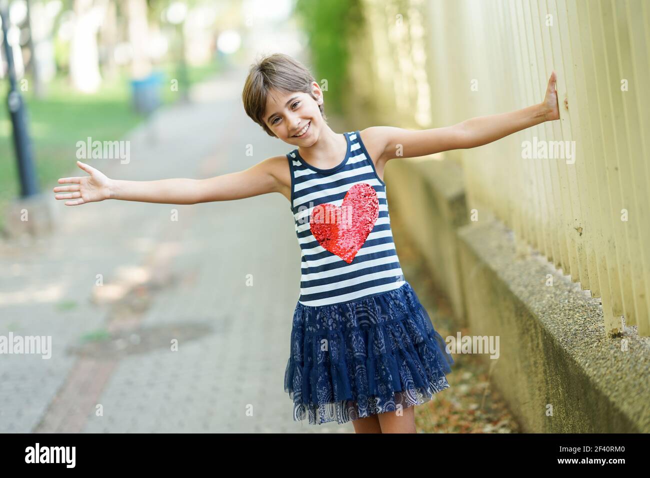 Little girl, eight years old, having fun in an urban park.. Little girl, eight years old, having ...