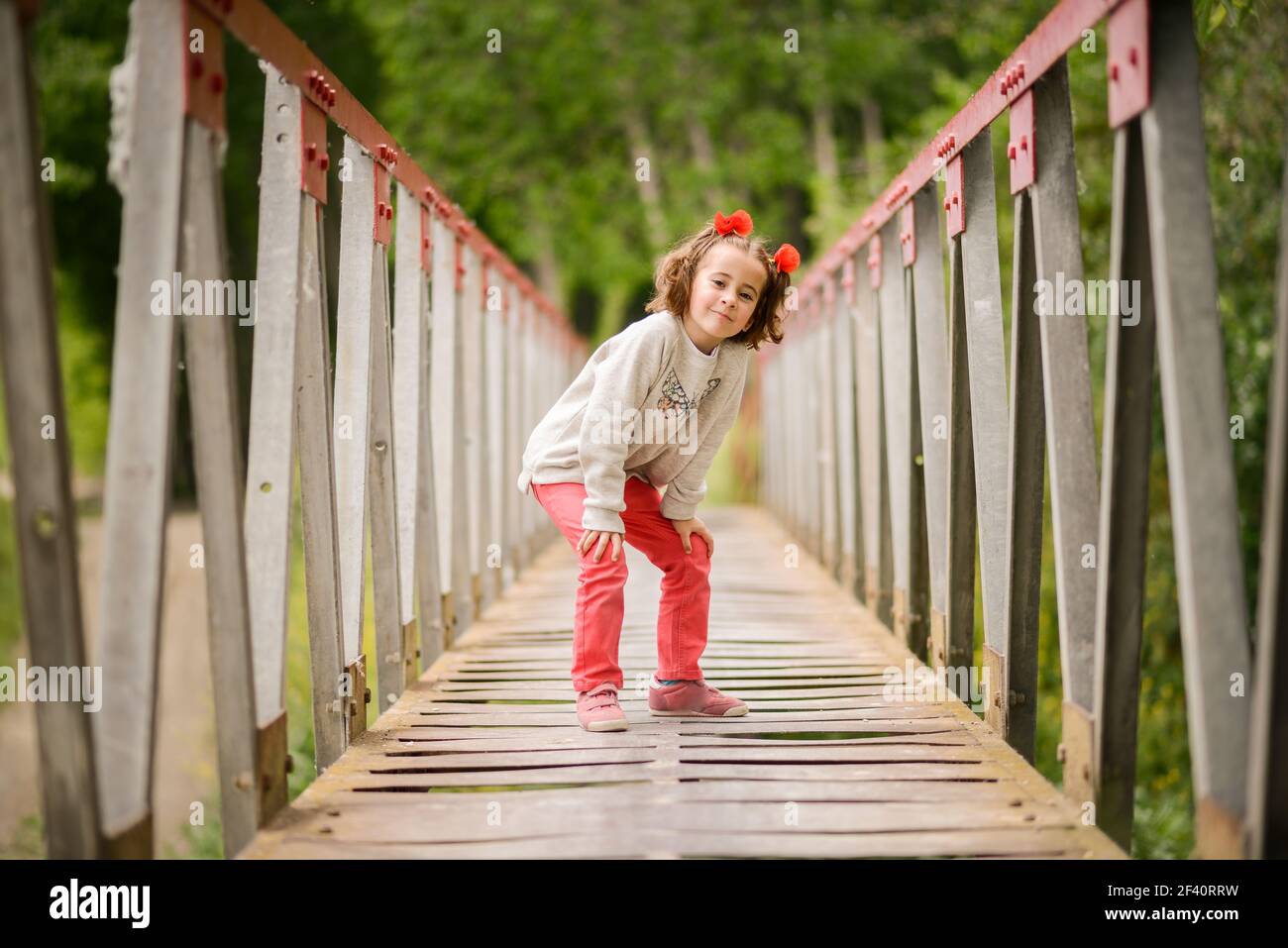 Cute little girl with four years old having fun in a rural bridge. Cute ...