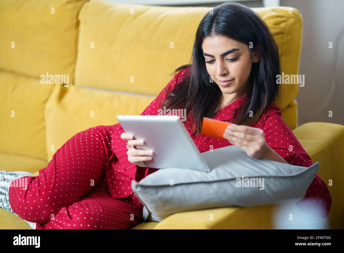Woman purchasing something online paying with her credit card. Girl ...