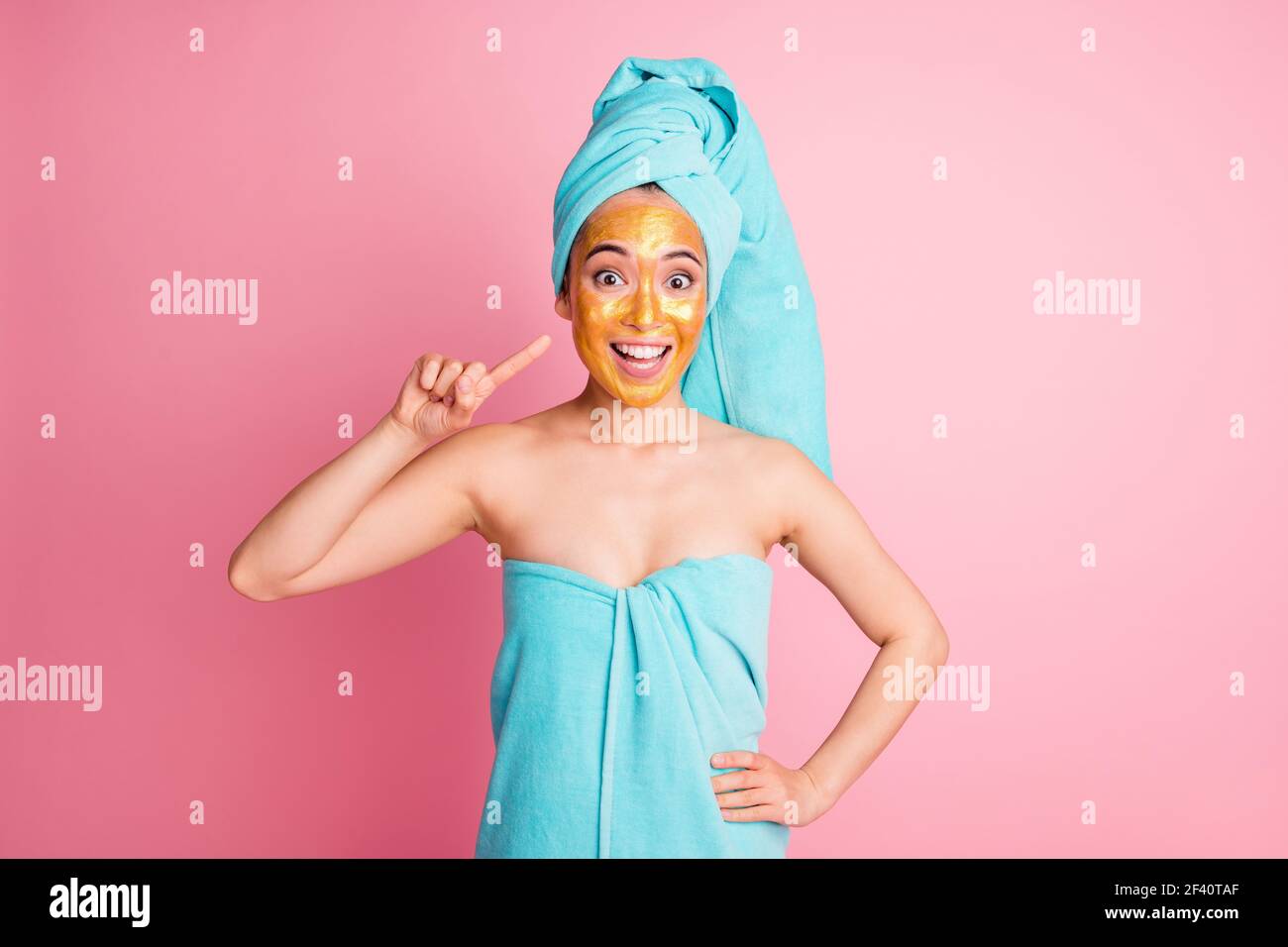 Photo of happy amazed young woman point face mask smooth skin recommend ...