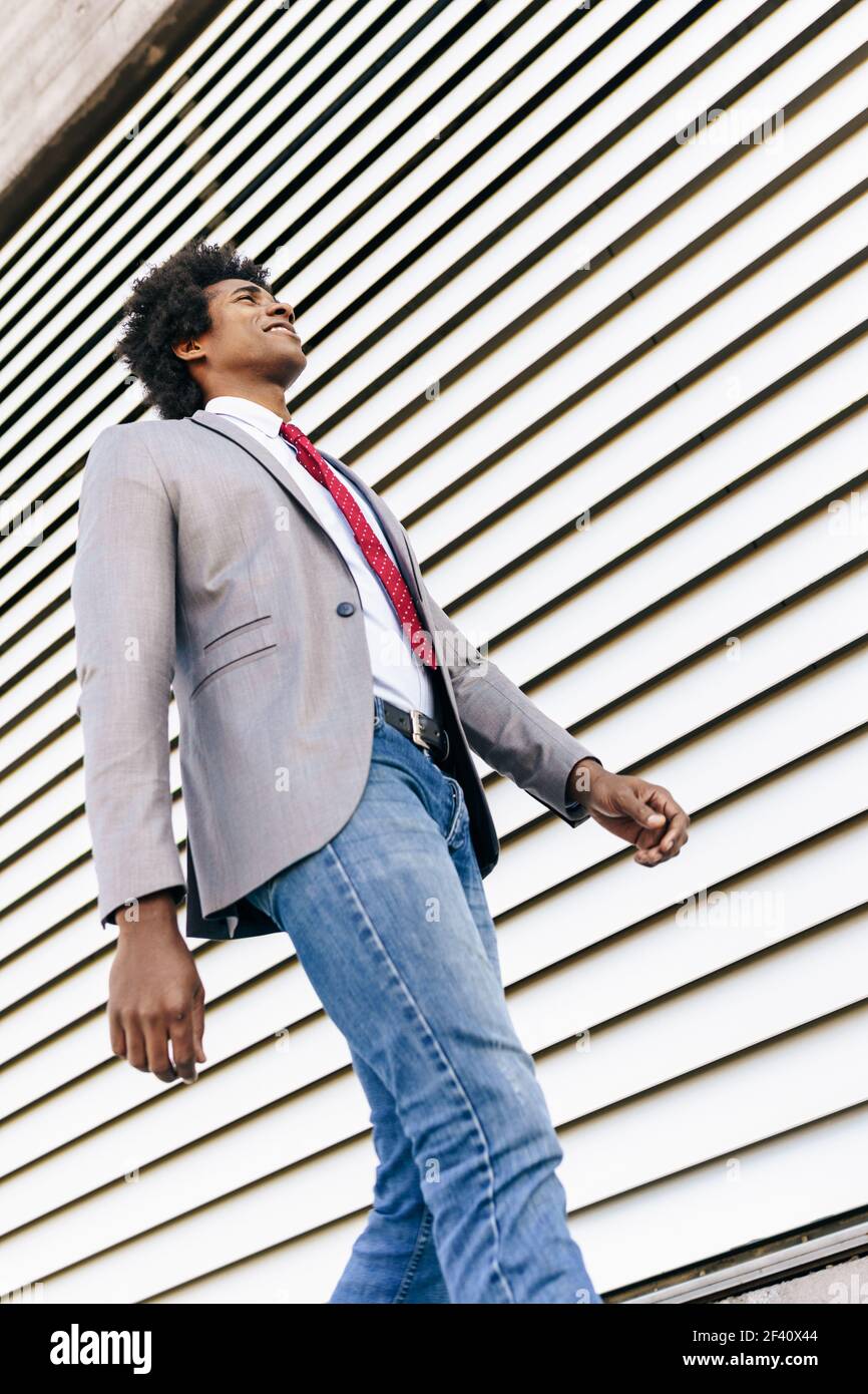 Black confident Businessman wearing suit walking in urban background ... Black confident Businessman wearing suit walking in urban background ...