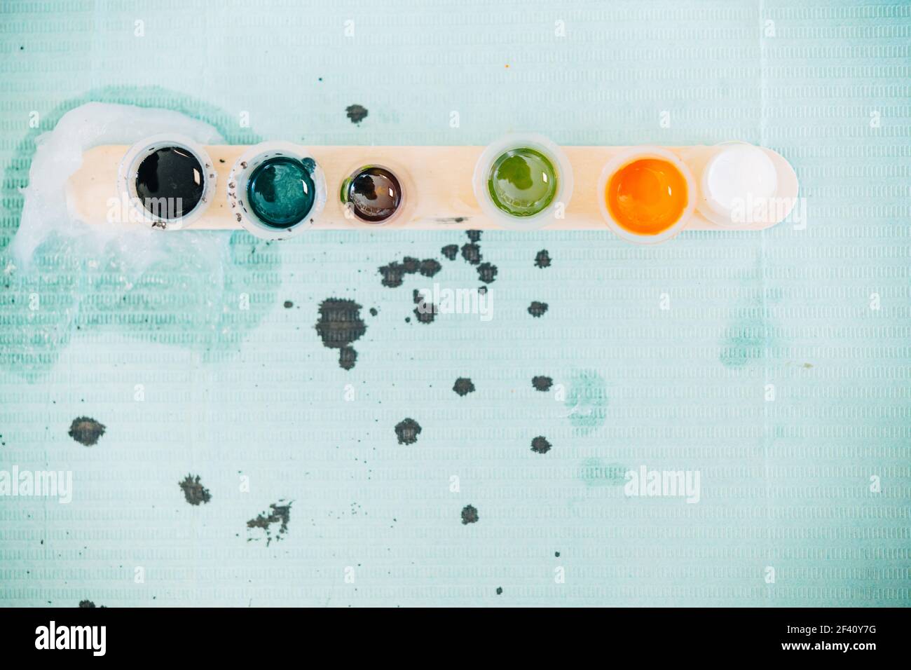 Little tattoo ink bottles full of different colors. Tattoo concept ...