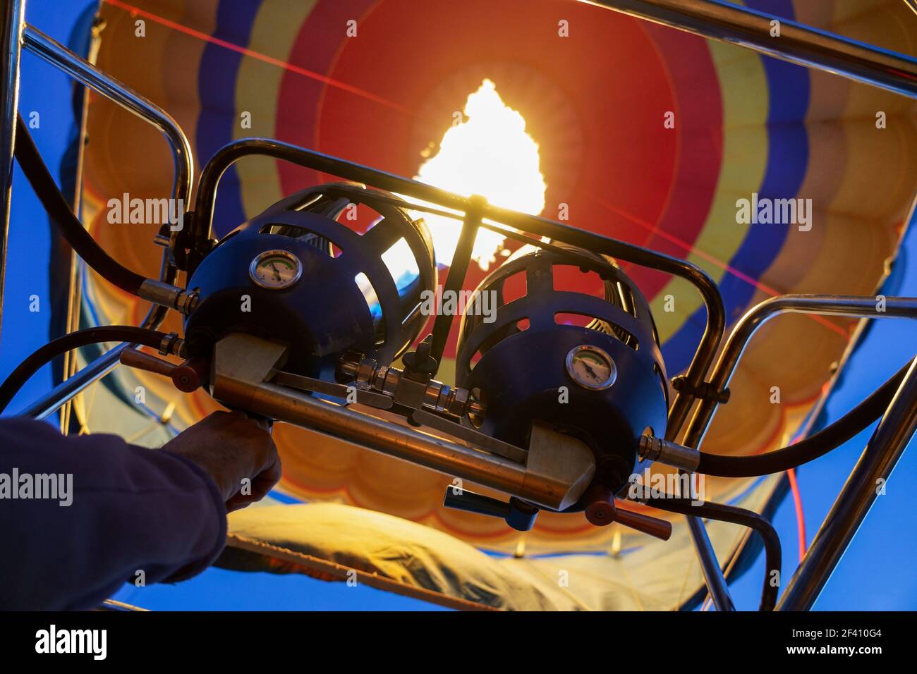 Pilot lighting the burners to heat the air inside the balloon for ...