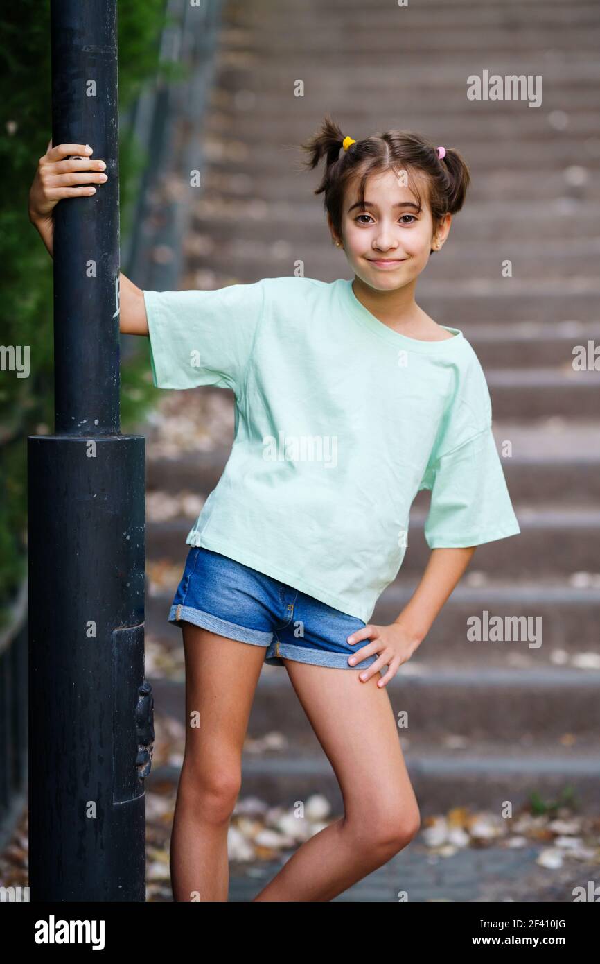 Nine-year-old girl standing on the steps of a city park.. Nine-year-old ...