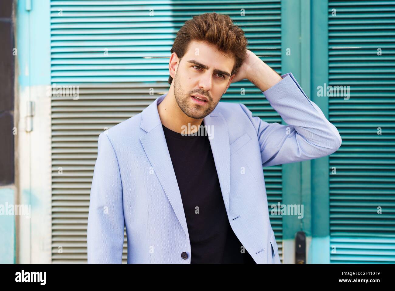 Attractive young man wearing suit standing outdoors.. Attractive man ...