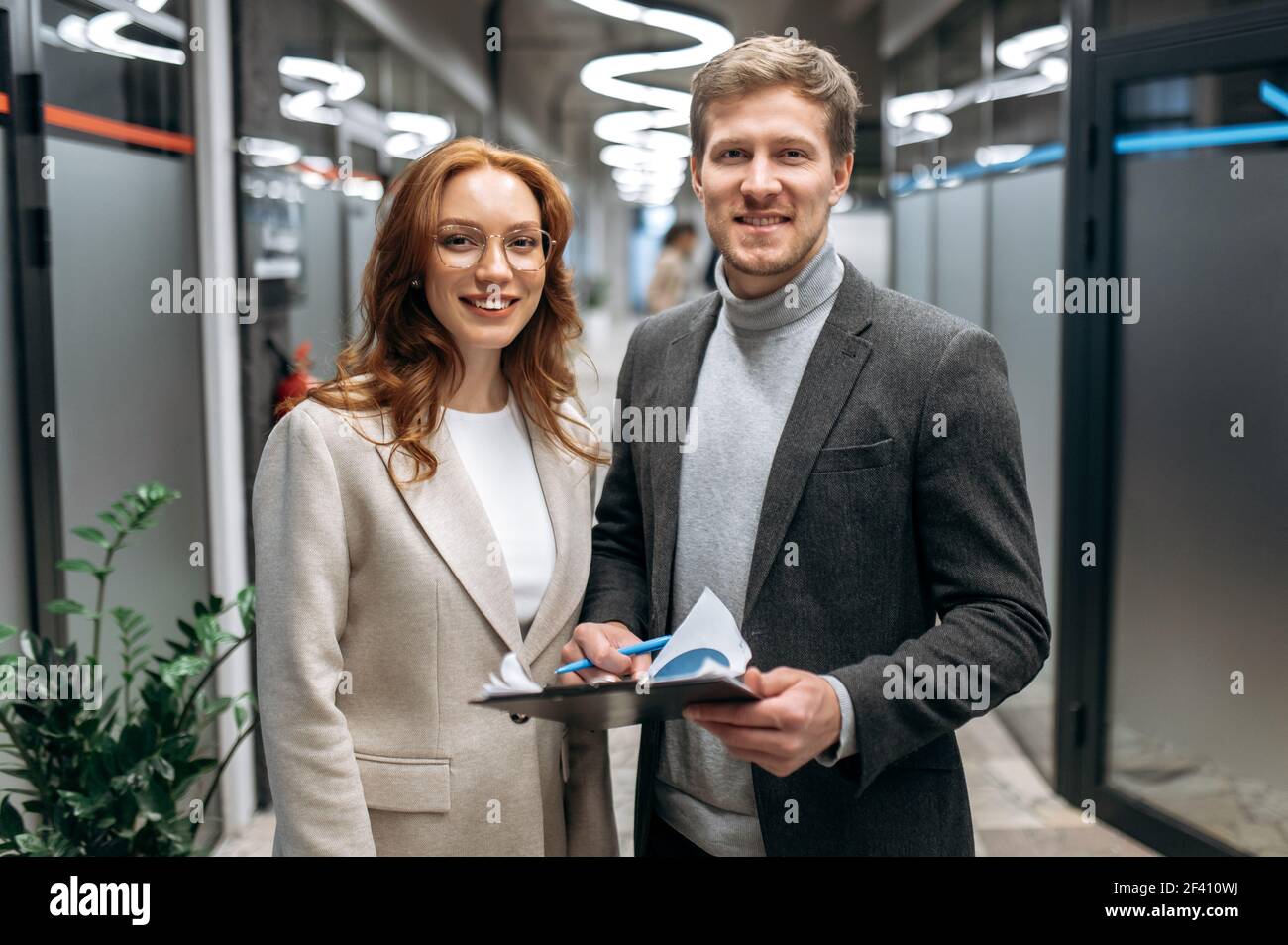 Portrait of happy successful business partners in modern office ...