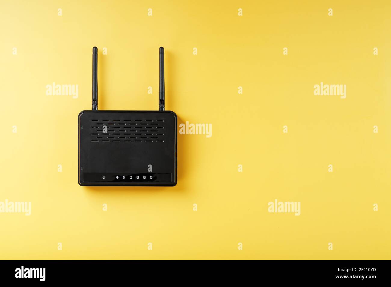 Wi-Fi router in black on a yellow background with free space. Internet ...