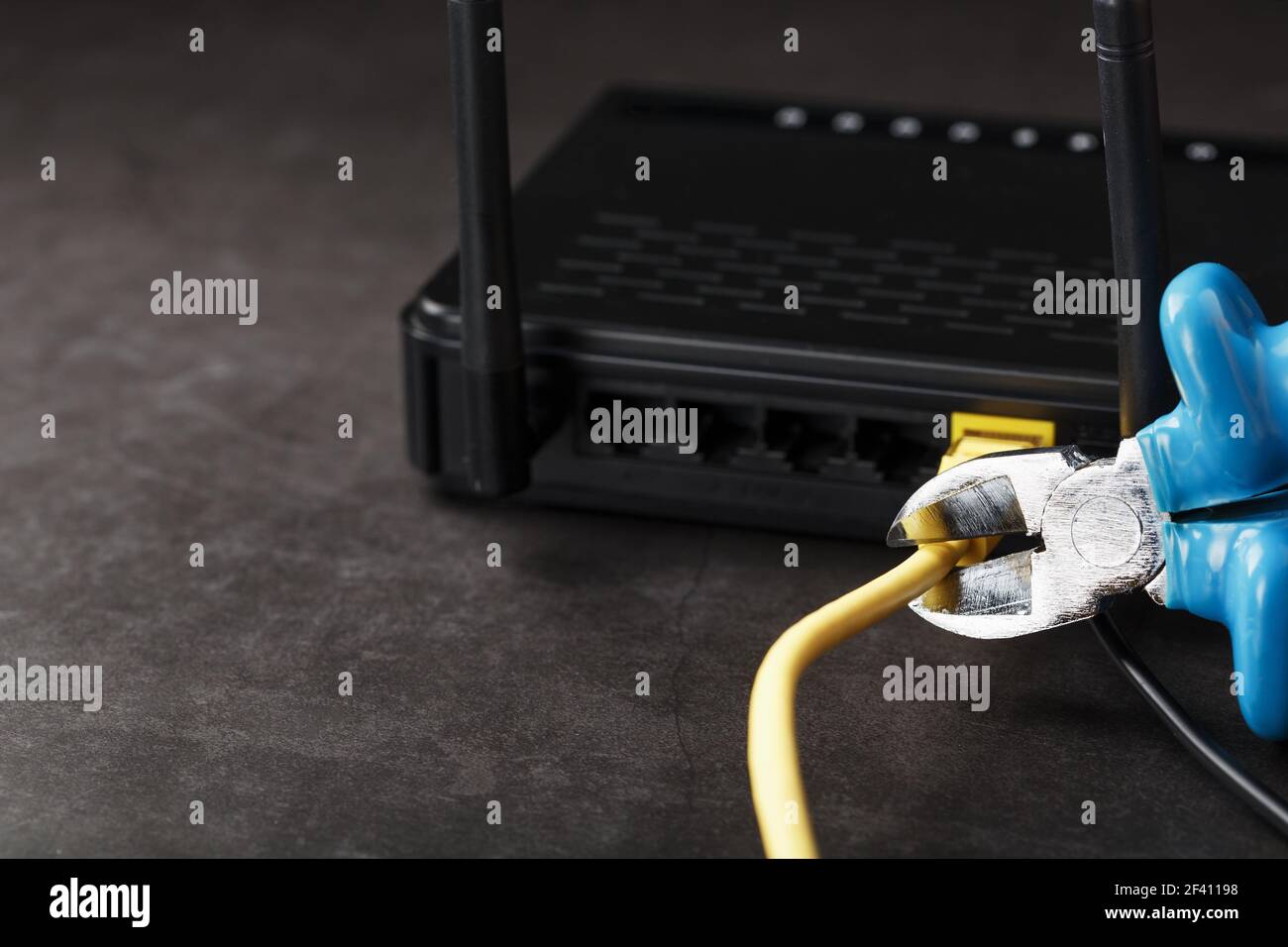 Tearing and cutting with blue wire cutters the network connection of ...