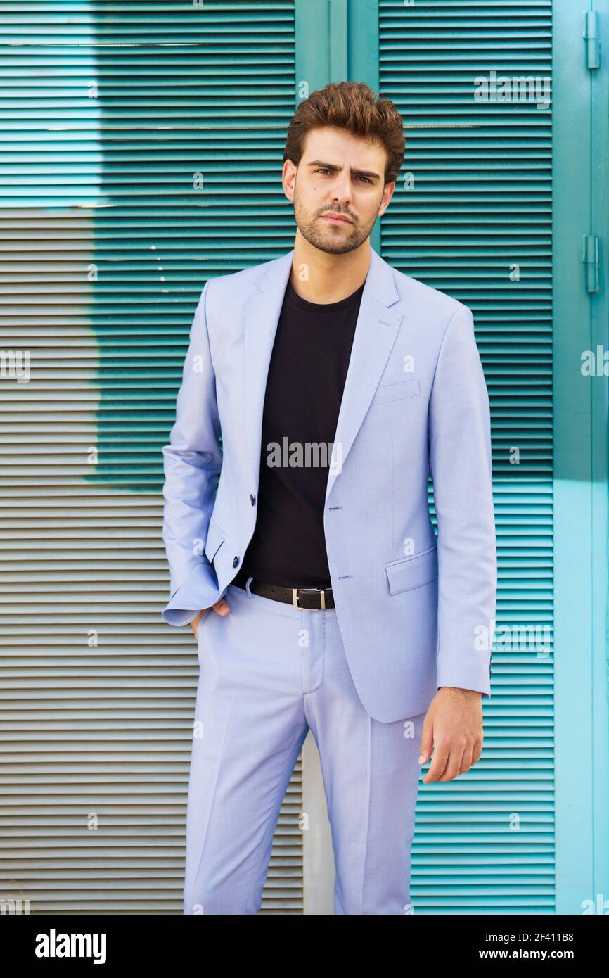 Attractive young man wearing suit standing outdoors.. Attractive man ...