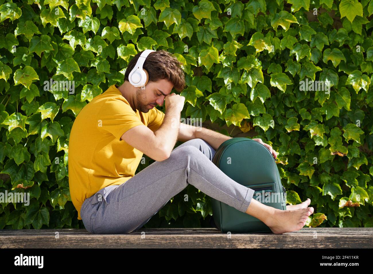 Male student sitting outside worried about his exams. Young student ... Male student sitting outside worried about his exams. Young student ...