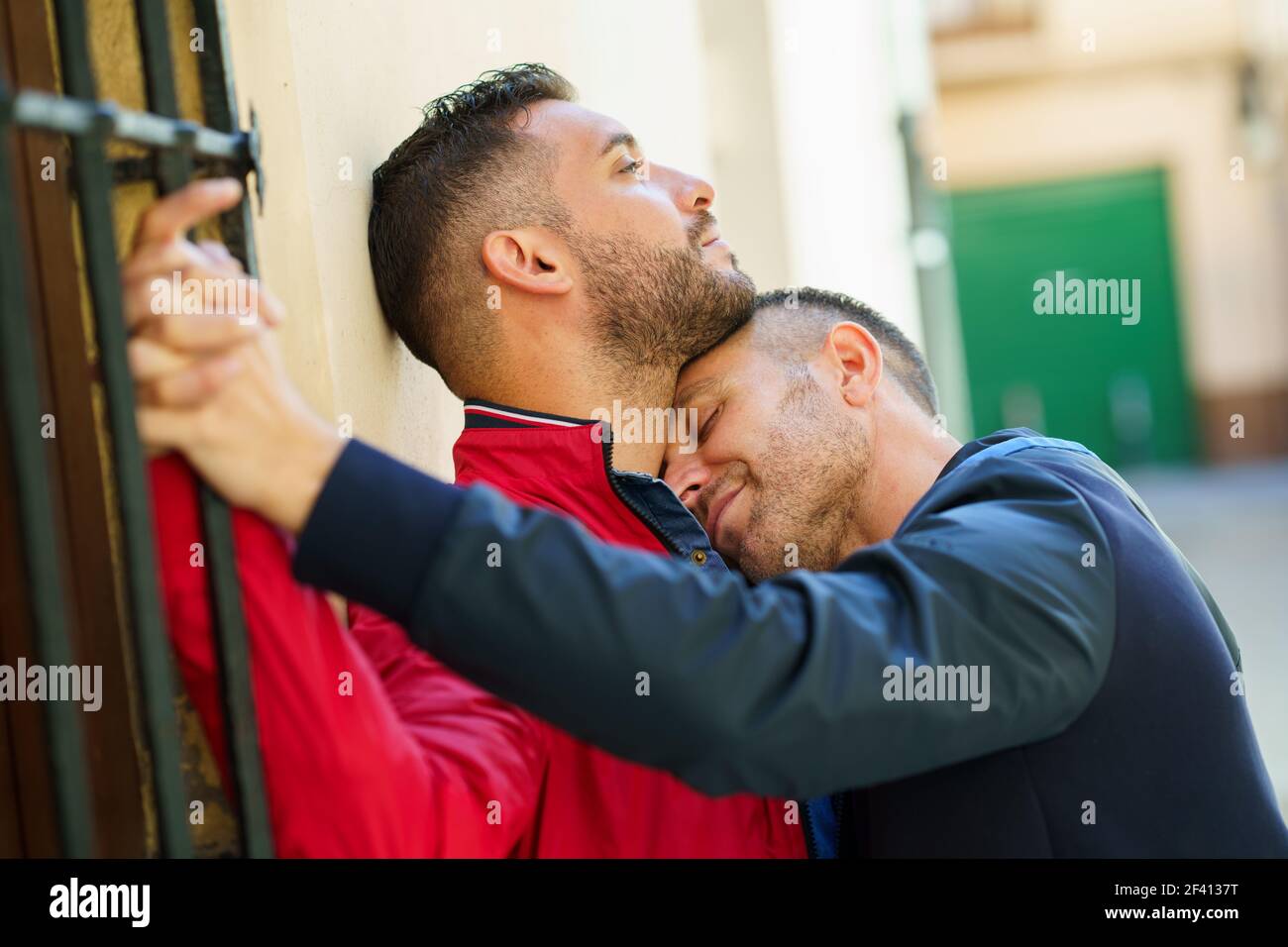 Gay couple in a romantic moment in a beautiful place near the river ...