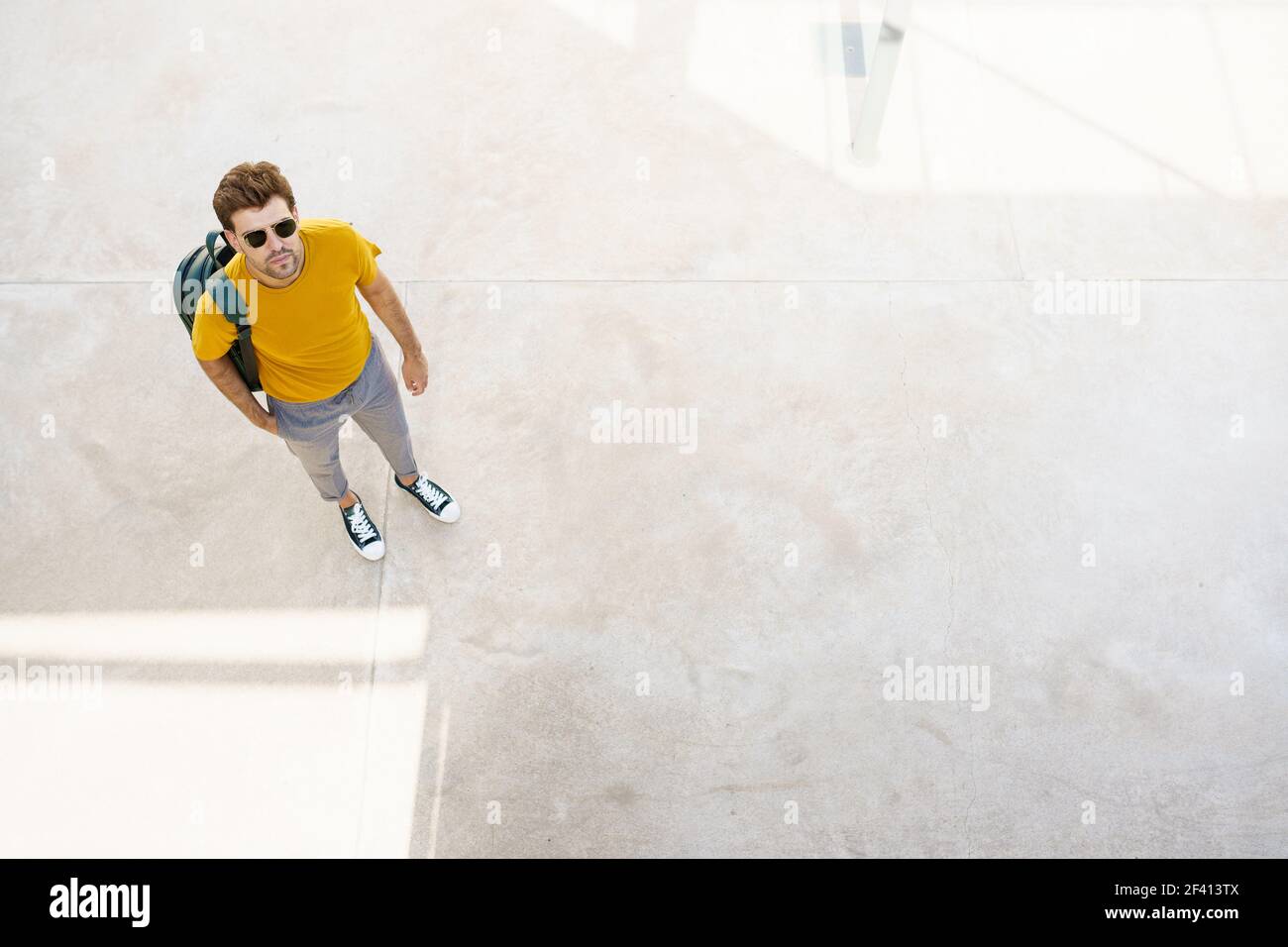 Top view of a male student on the university campus. Young man in urban ...