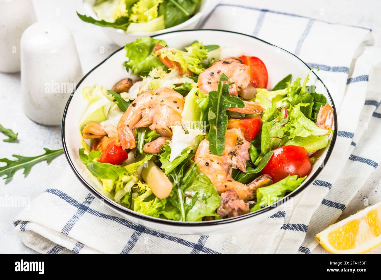 Seafood salad with green leaves and vegetables Stock Photo - Alamy