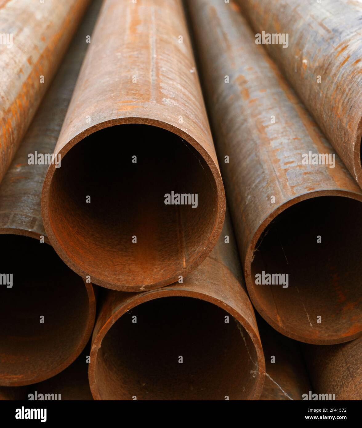 Rusty metal pipes in pile view from the end. Rusty metal pipes in pile ...