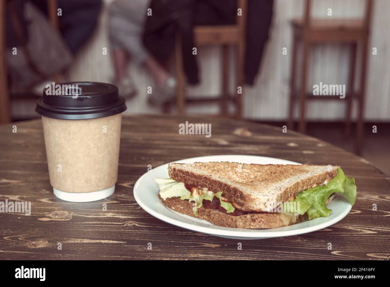 Triangle sandwich and takeaway coffee cup of craft paper on wooden ...