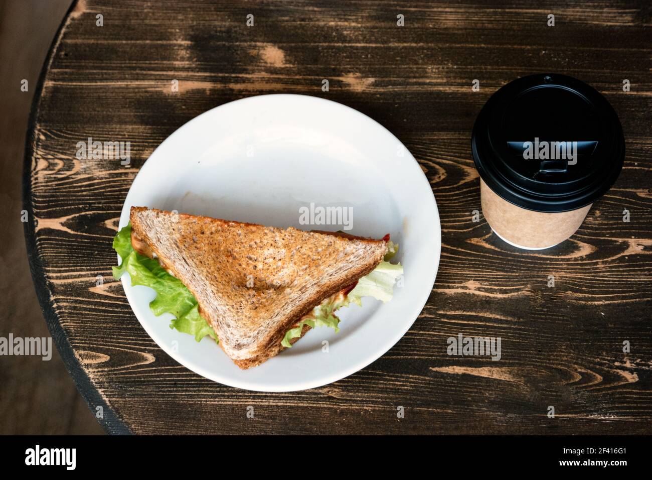 Lunch with triangle sandwich on dark table background top view ...