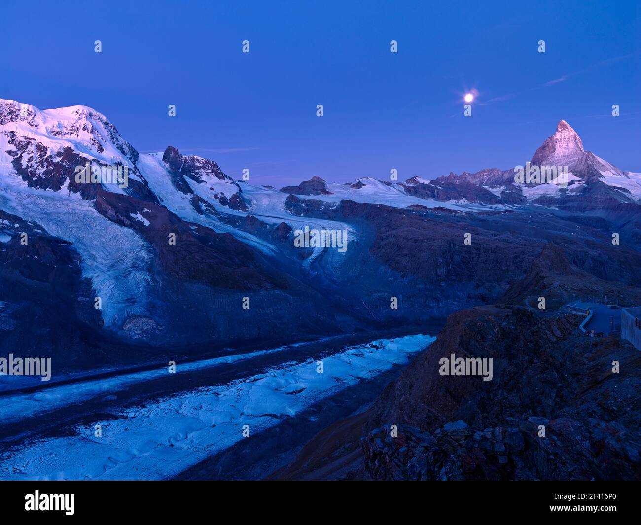 Switzerland,Zermatt, moon setting at dawn over the Matterhorn and the ...
