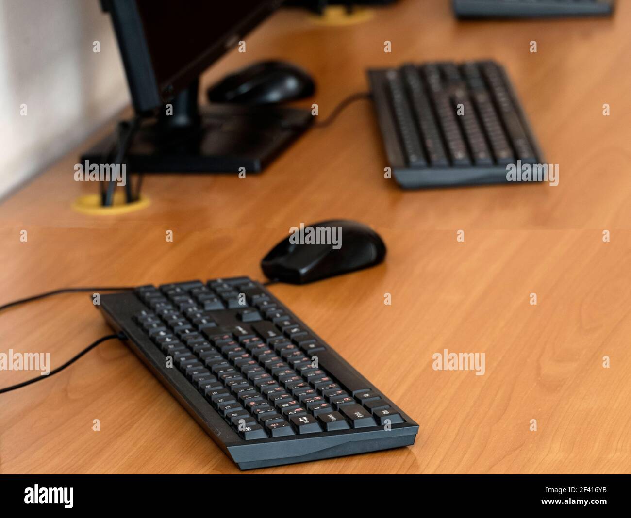 Empty computer class room tables with keyboards from above. Empty ...