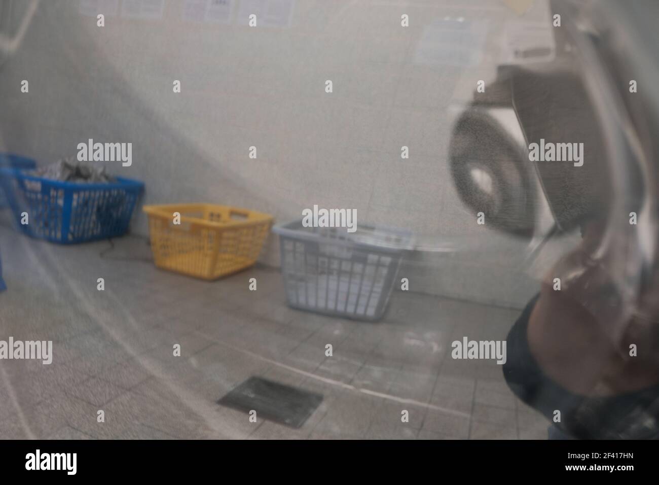 Basket with laundry as reflection in washing machine door, copyspace ...