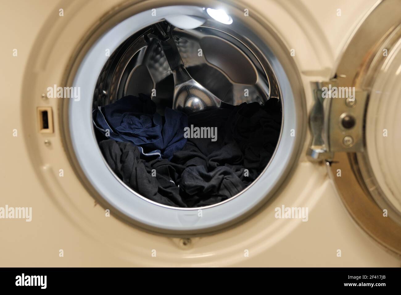 Closeup of Open washing machine with dirty clothes inside drum Stock ...