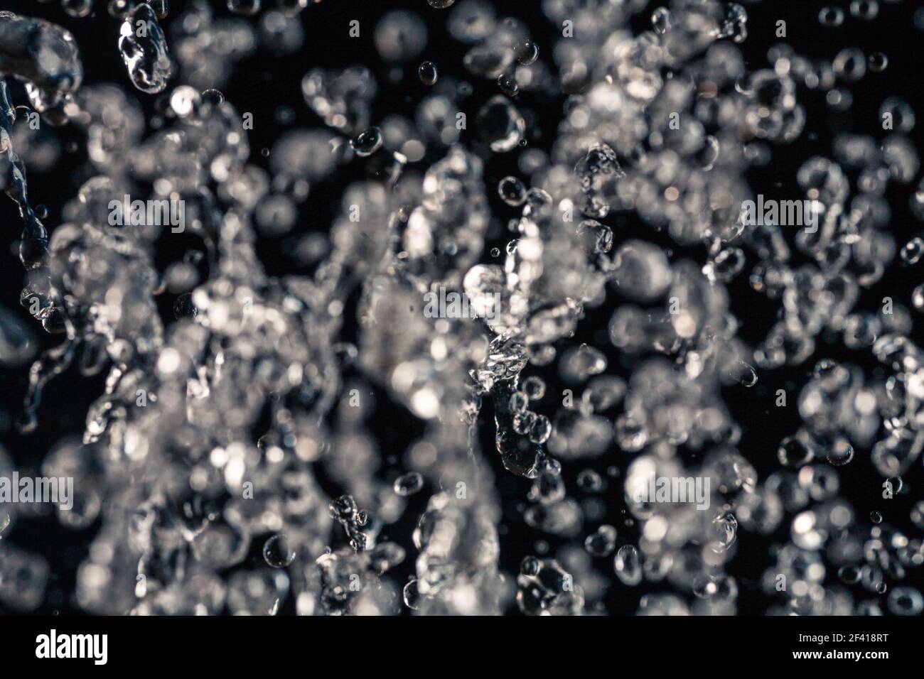 Half defocused half in focus water drops frozen in an air. Half ...