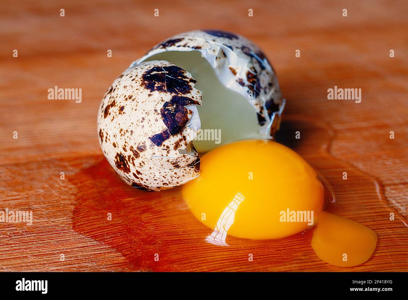 Shell And Yolk. Broken Quail Egg On Wooden Cooking Board Angle View ...