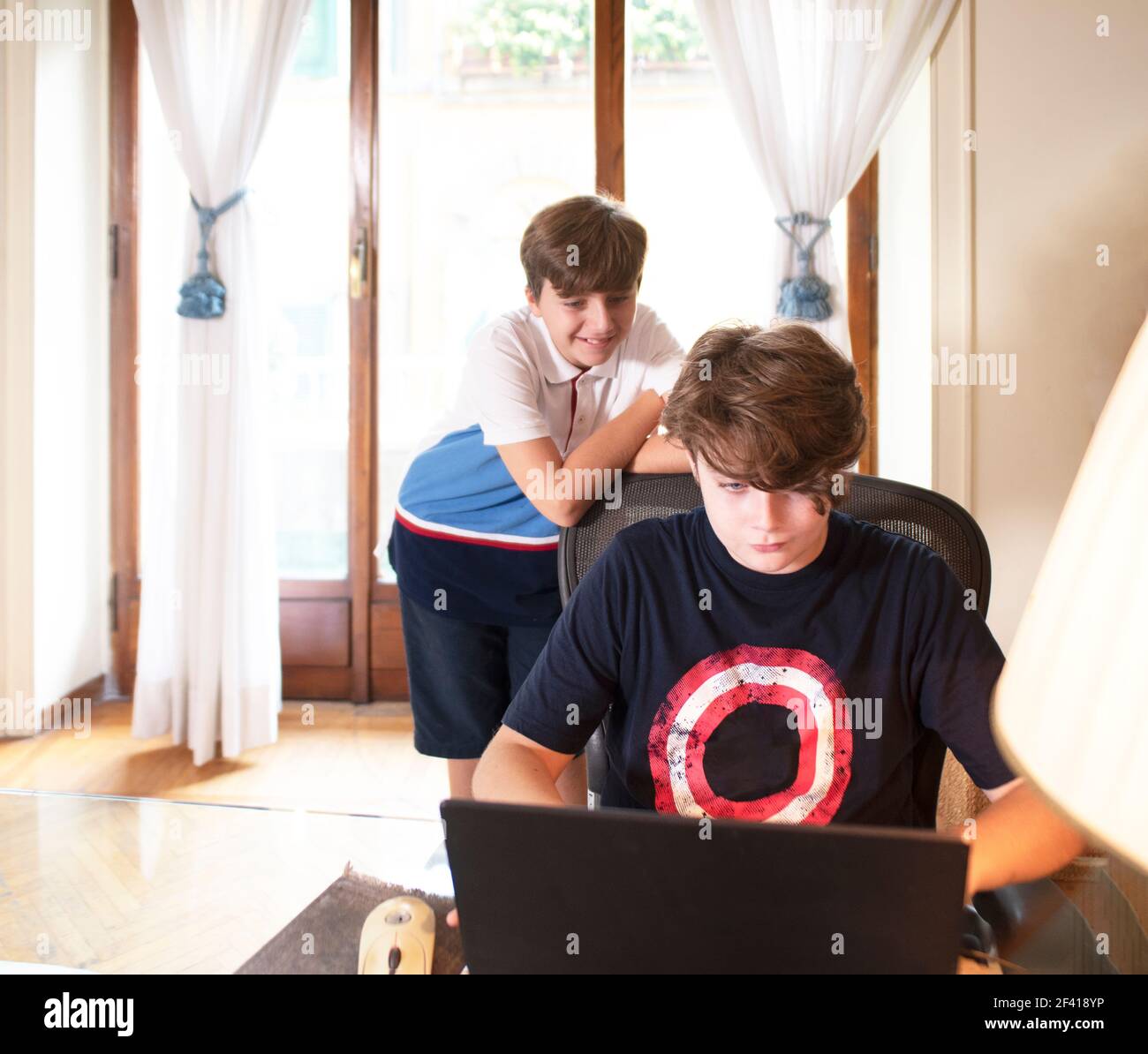 teen boys school students watching online webinar learn on laptop sit ...