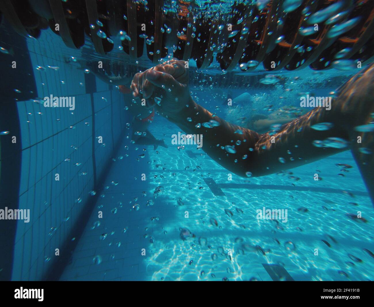 Boys hand underwater in swimming pool. Boys hand underwater Stock Photo ...