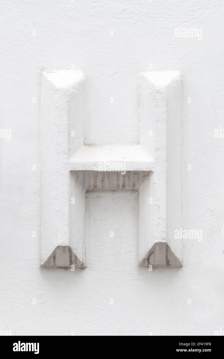 White stucco letter H on white ground Stock Photo - Alamy