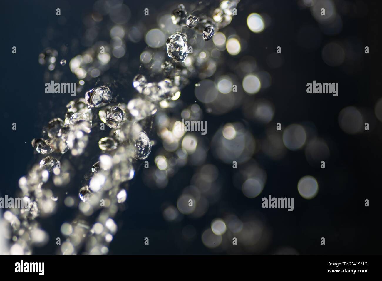 Flying drops of water on dark background shot with copyspace Stock ...