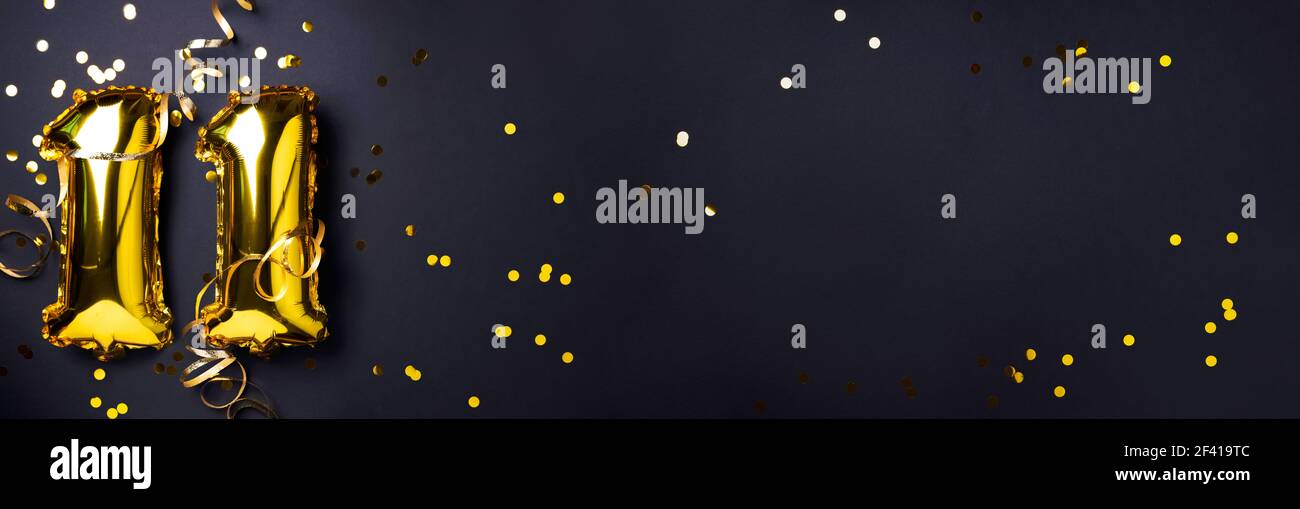 Gold foil balloon number, digit eleven. Birthday greeting card ...