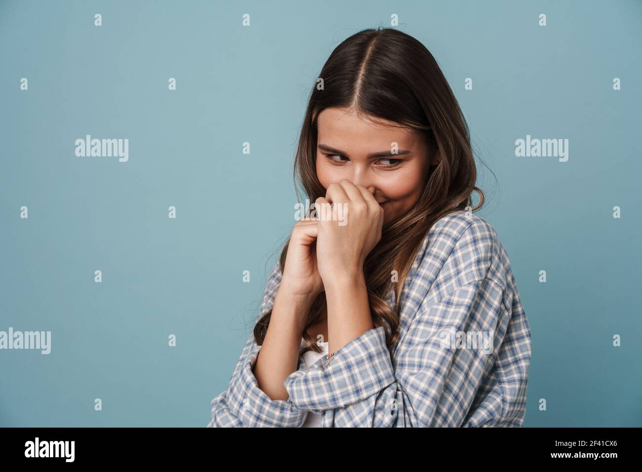 Happy beautiful modest girl smiling and looking downward isolated over ...
