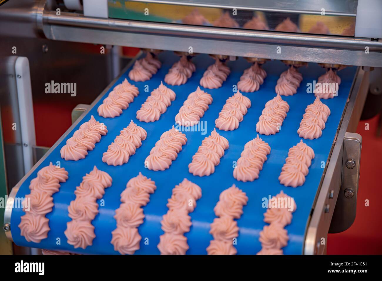 Cakes on automatic conveyor belt , process of baking in confectionery ...
