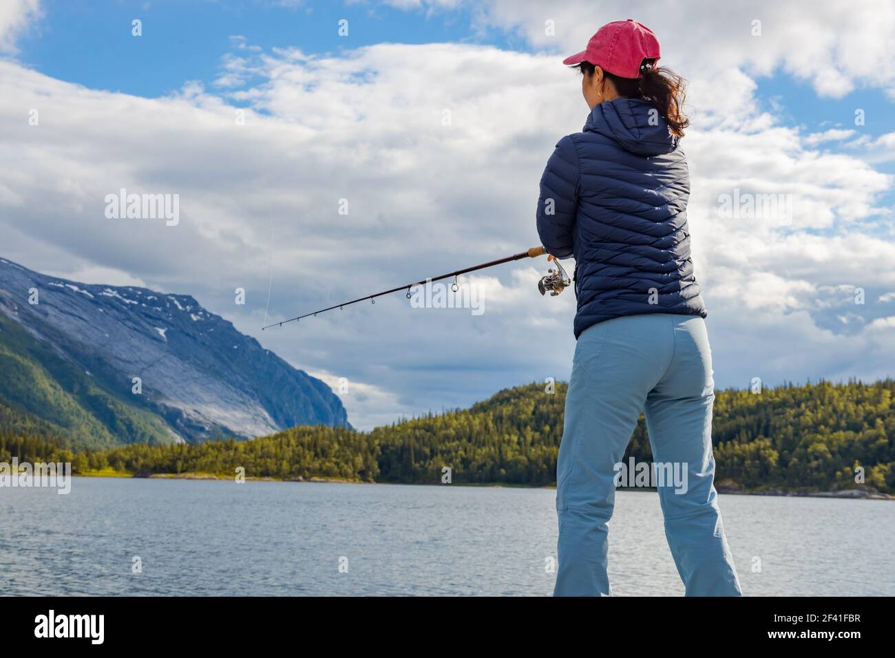 Woman fishing on Fishing rod spinning in Norway. Fishing in Norway is a ...