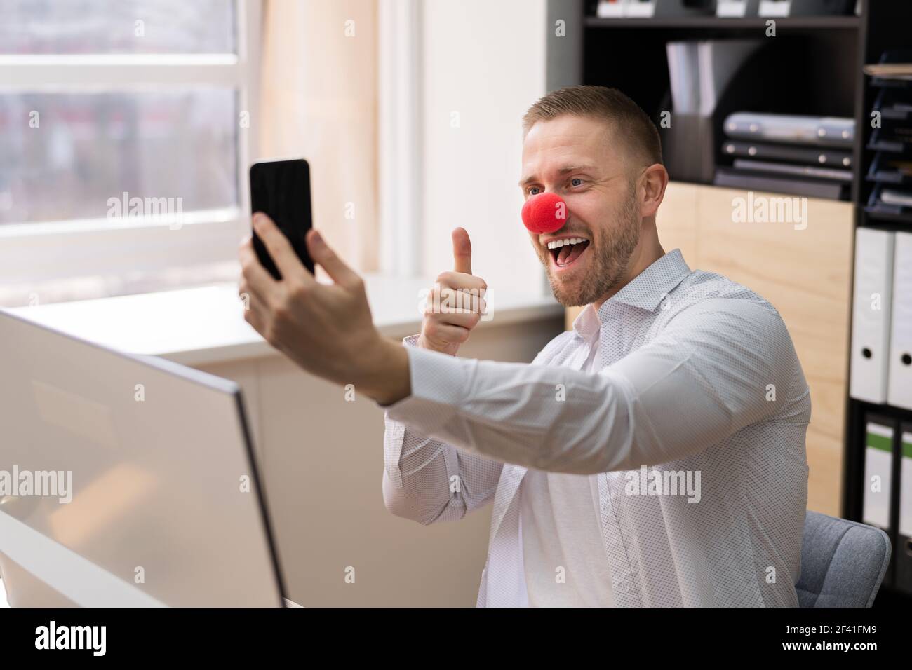 Happy Working People Using Mobile Phone In Office Stock Photo - Alamy