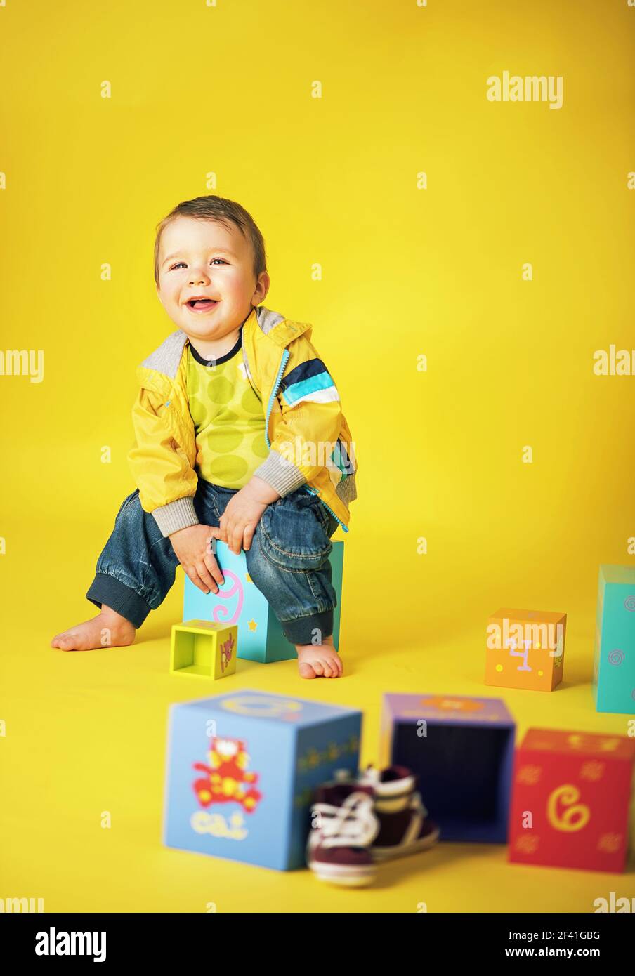 Portrait of a laughing little boy with a bunch of toy bricks Stock ...