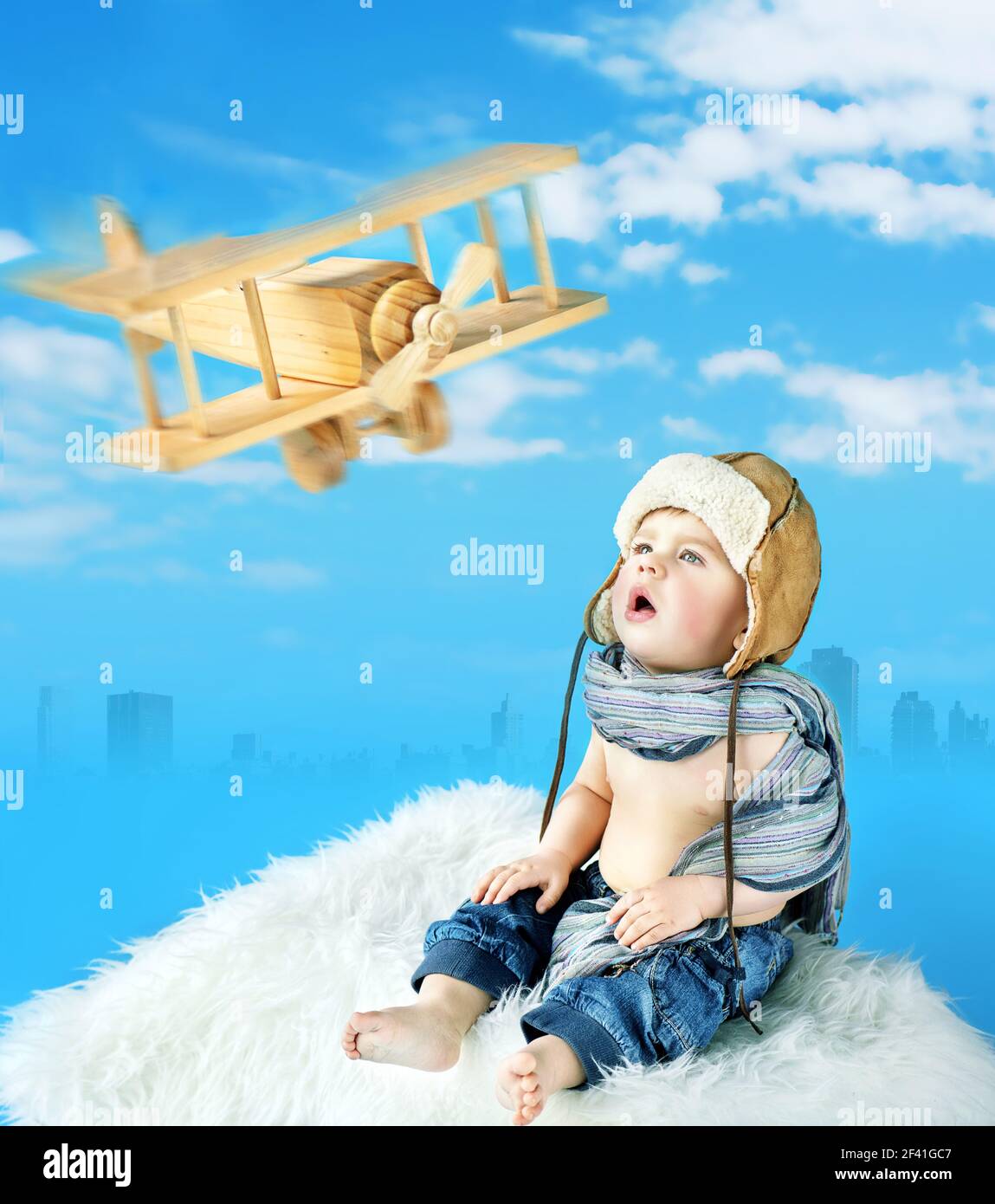 Little pilot looking at the toy aircraft Stock Photo - Alamy